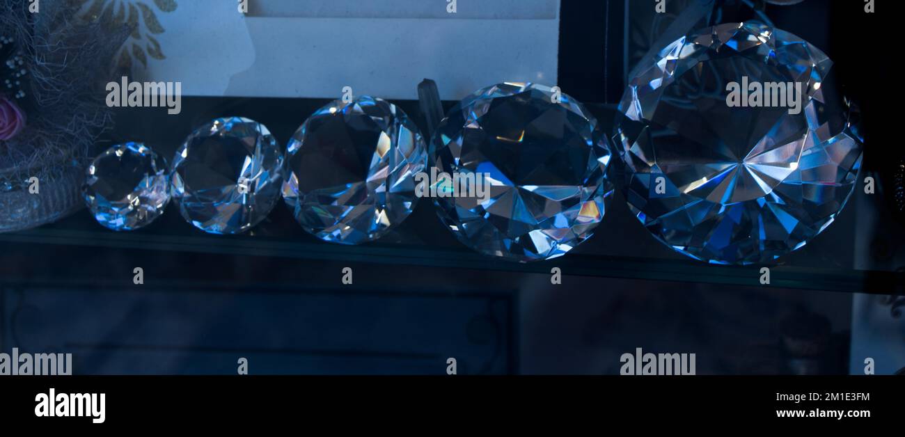 Five transparent diamonds aligned from small to big on display Stock ...