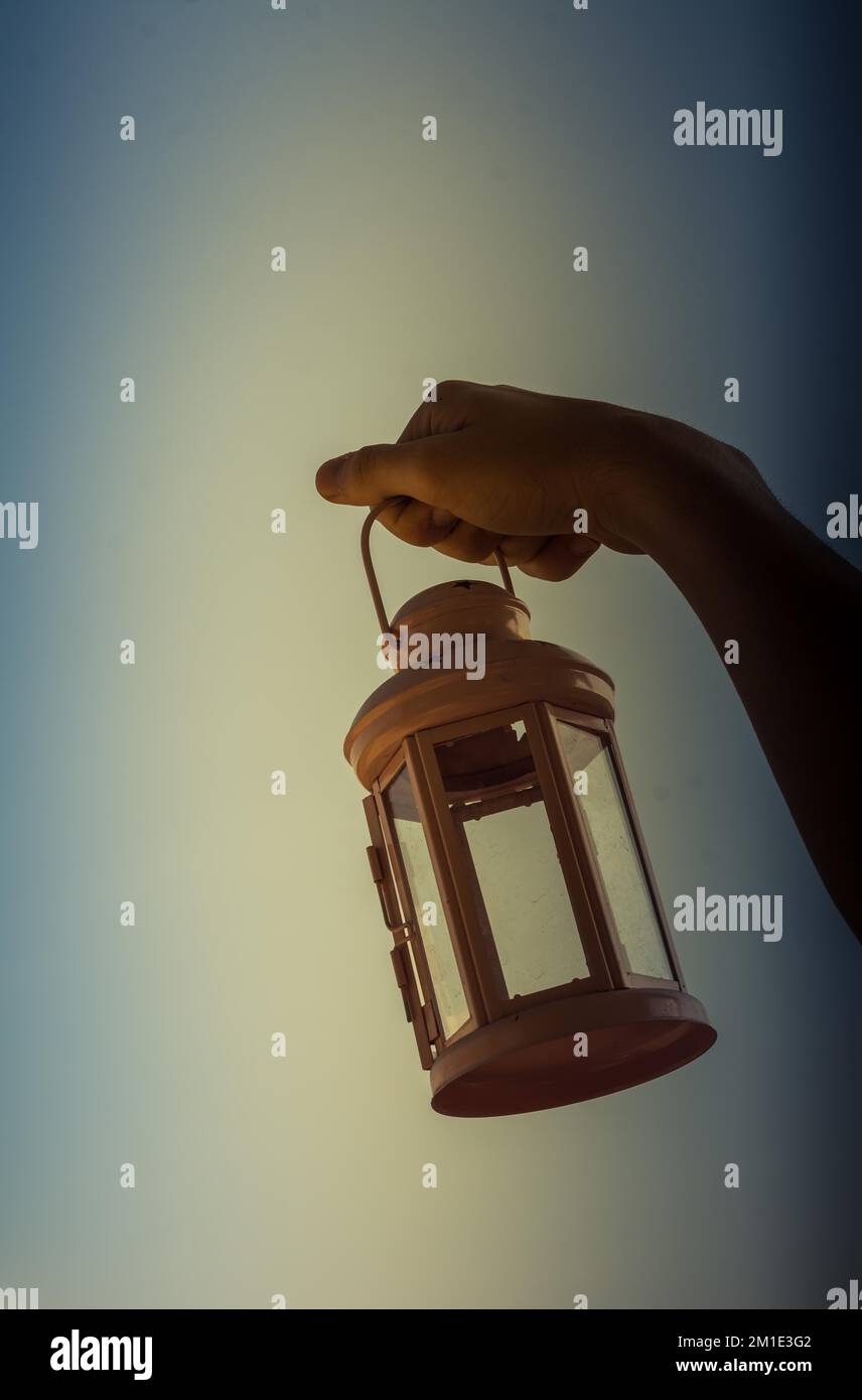 Old retro style lantern made of metal in hand Stock Photo - Alamy