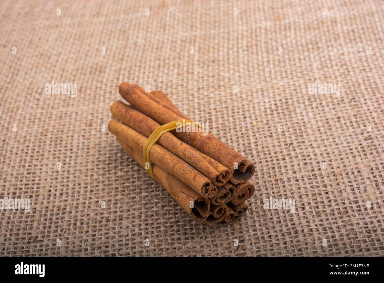 Bundle of cinnamon sticks on a linen canvas background Stock Photo - Alamy