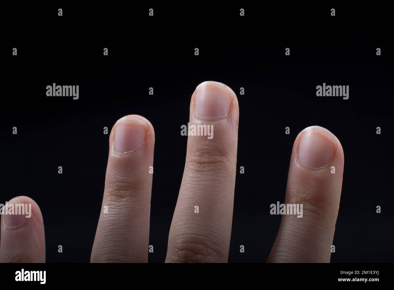 Four fingers of a child hand partly seen in black background Stock ...