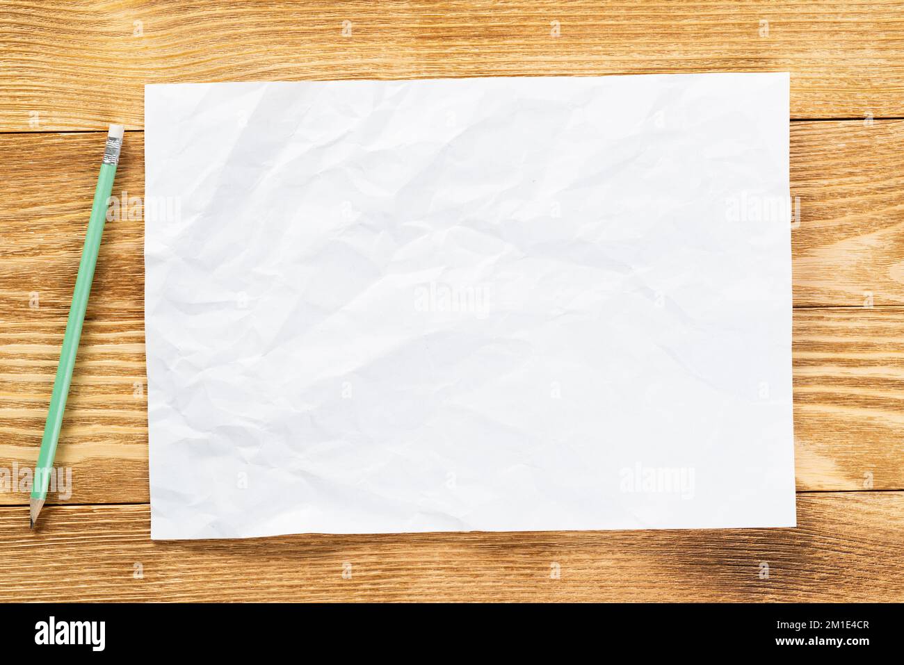 Sheet of paper lying on wooden table Stock Photo - Alamy