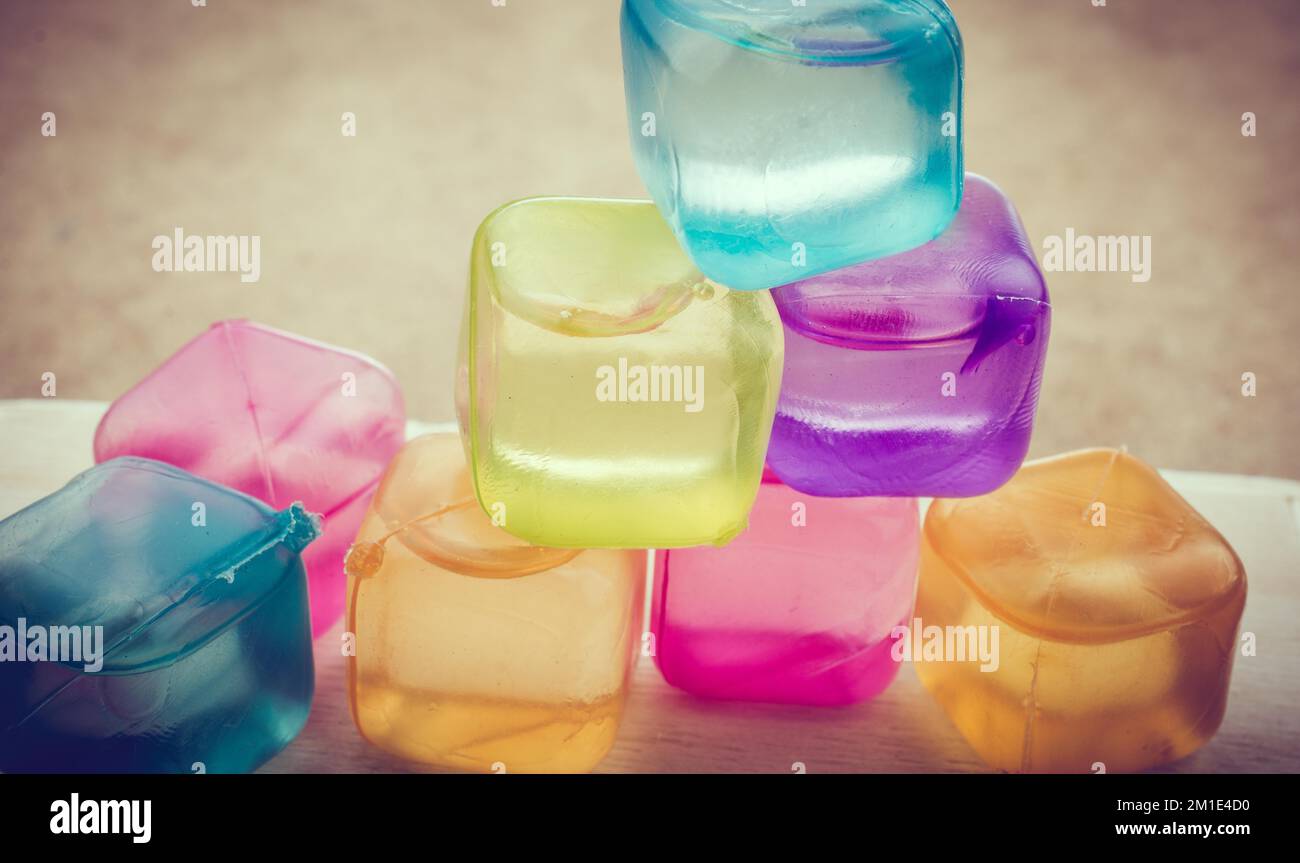 Fake colorful ice cubes on a brown background Stock Photo - Alamy