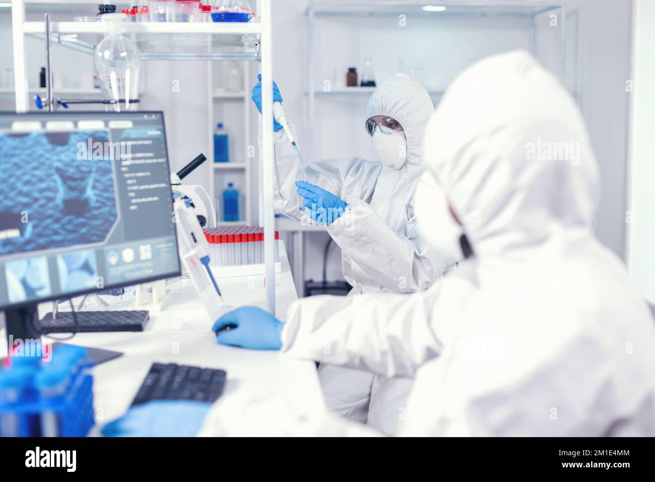 Experienced doctor taking sample from test tube using micropipette ...