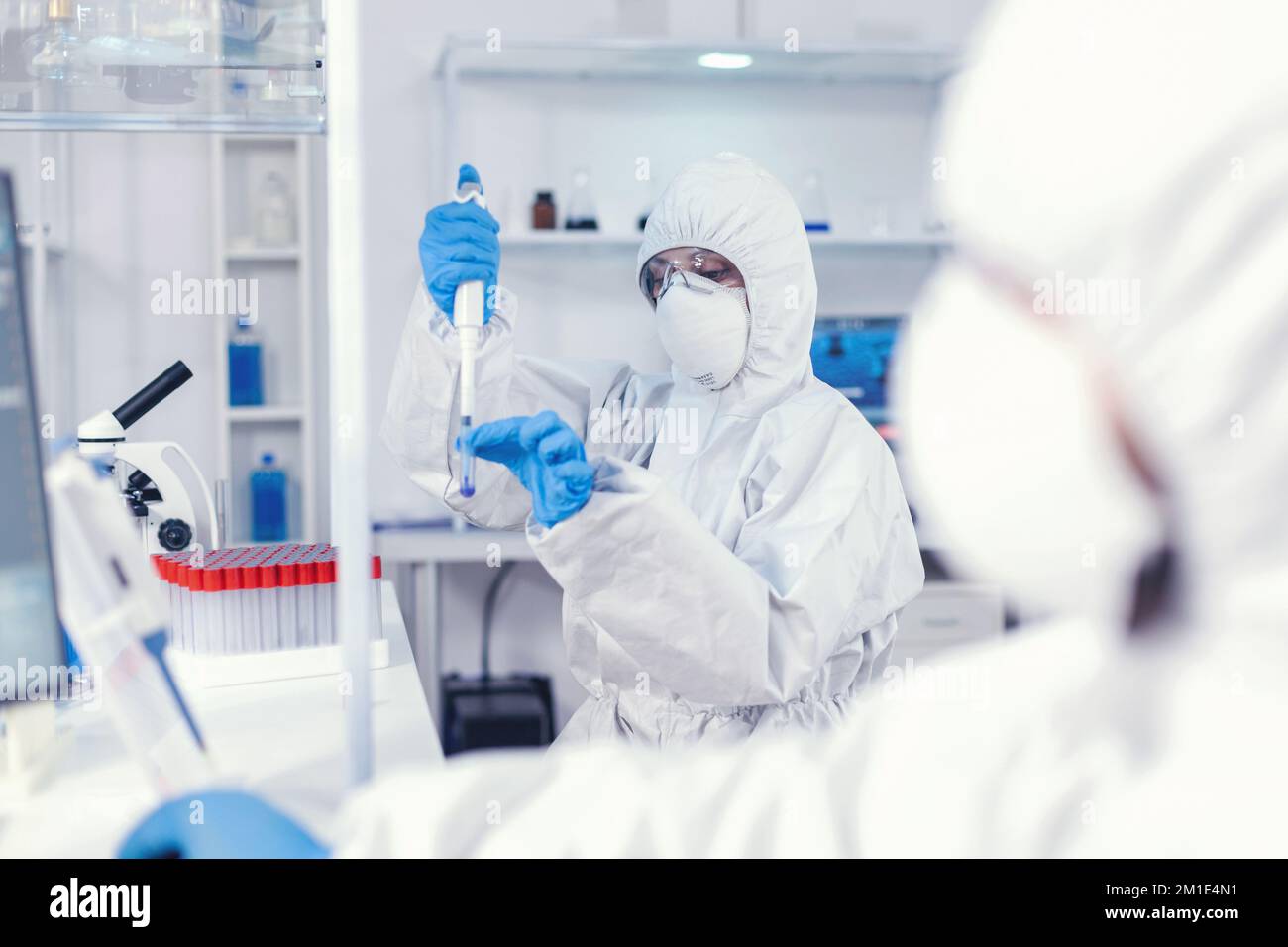 Medical scientist developing coronavirus vaccine in science lab holding ...