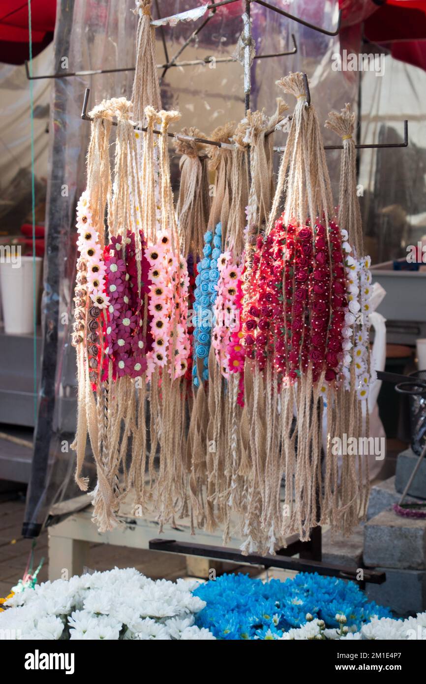 Colorful crowns for sale made of fake flowers Stock Photo - Alamy