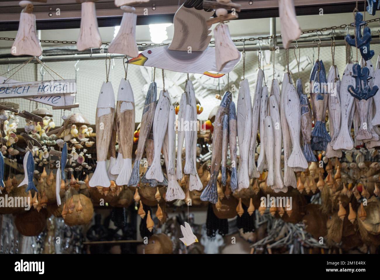 Beautiful wooden fish for decoration on a a string Stock Photo - Alamy