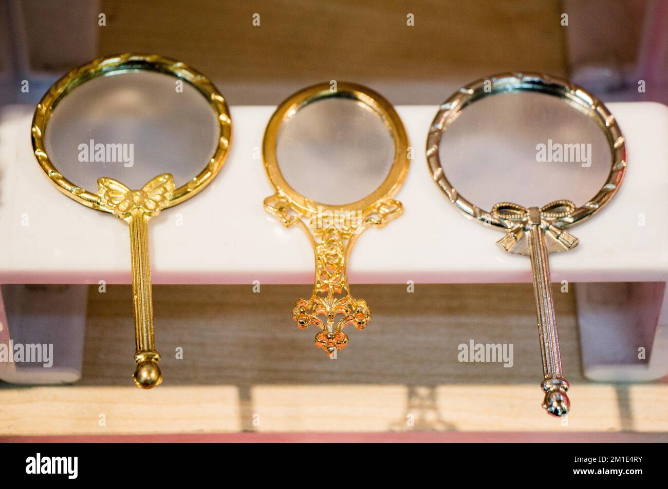 Little decorative gold color hand mirror on a shelf Stock Photo - Alamy
