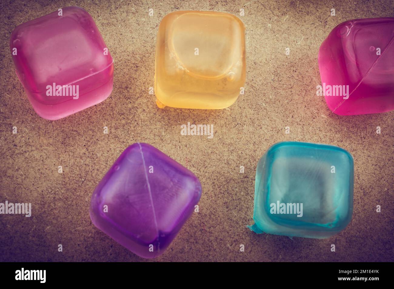Fake colorful ice cubes on a brown background Stock Photo - Alamy
