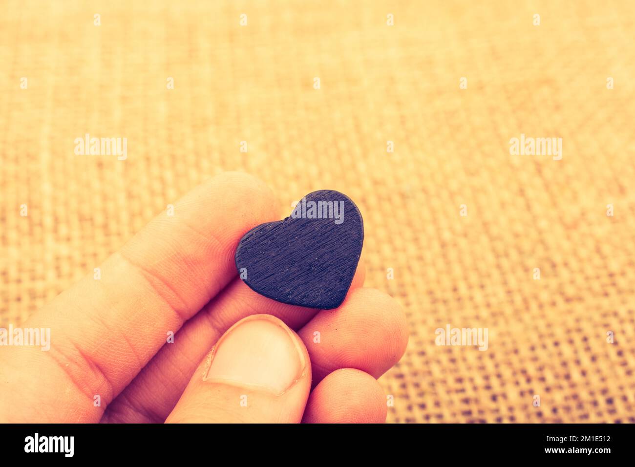 Heart shaped object in hand on canvas Stock Photo - Alamy