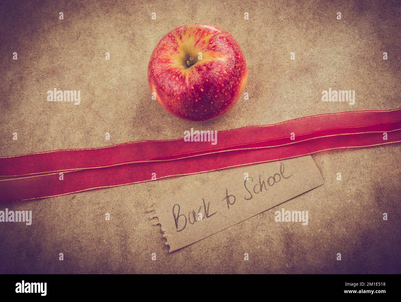 Back to school lettering with apple and a red ribbon Stock Photo - Alamy