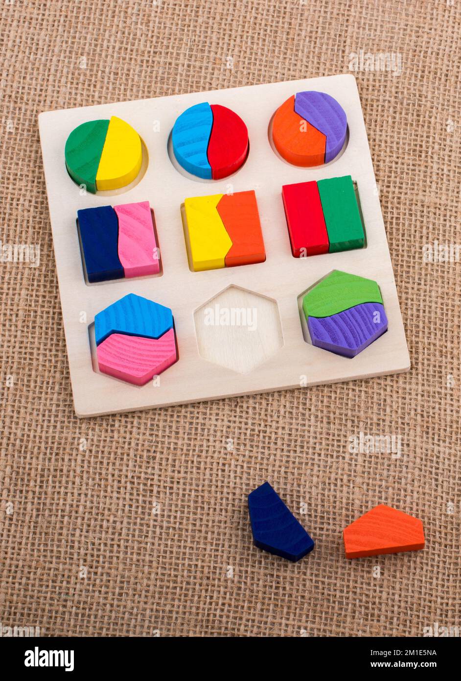 Colorful wooden pieces of a logic puzzle Stock Photo - Alamy
