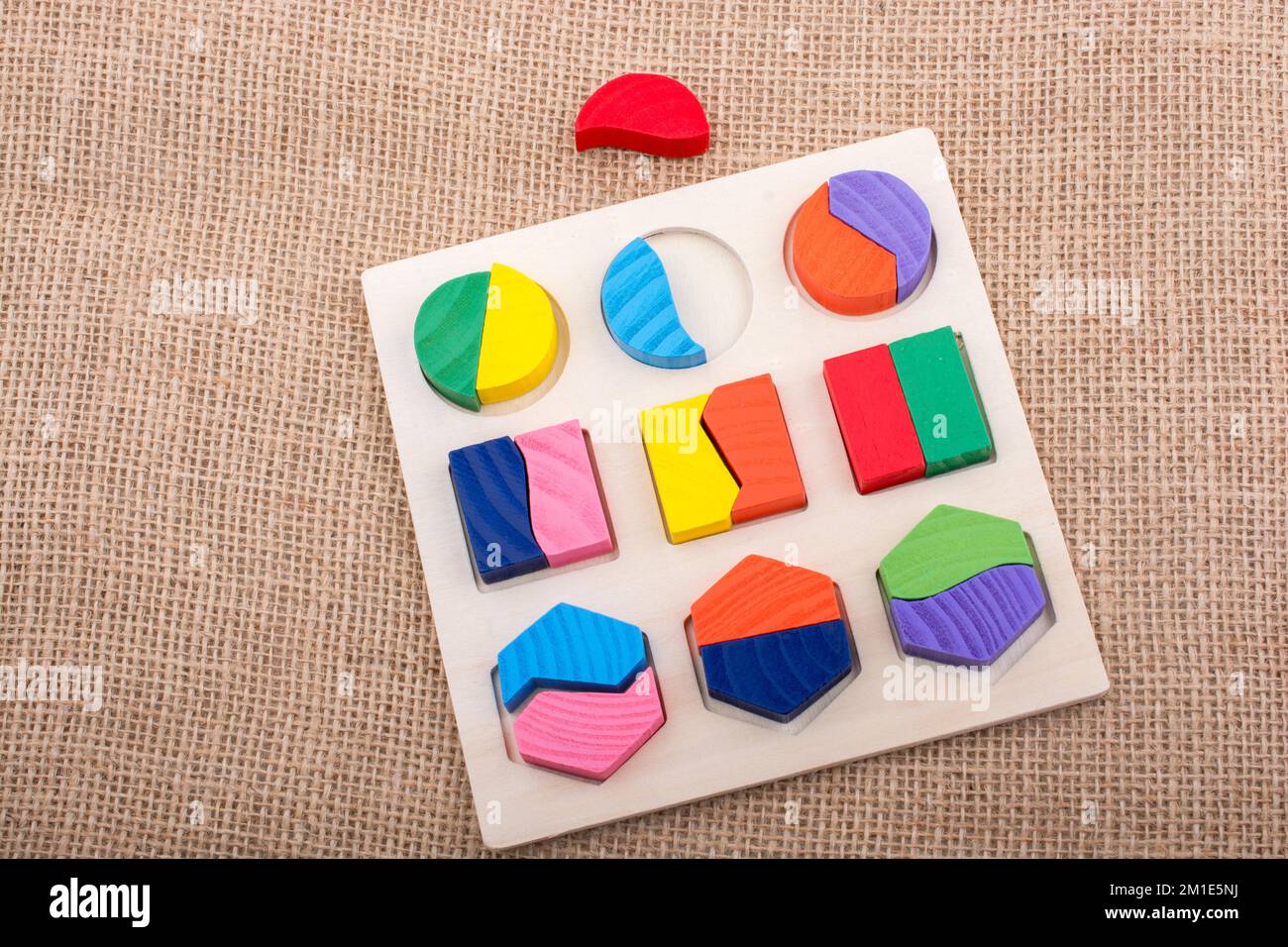 Colorful wooden pieces of a logic puzzle Stock Photo - Alamy