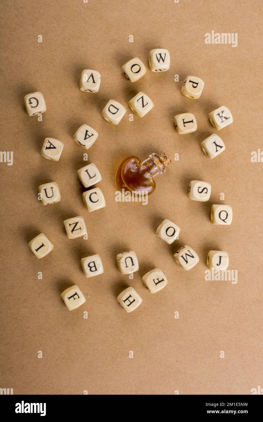 Wooden Letter cubes around love shaped bottle Stock Photo - Alamy