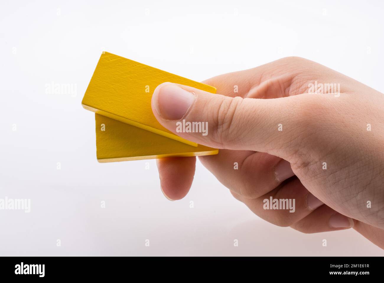 Hand holding yellow color domino pieces in hand Stock Photo - Alamy