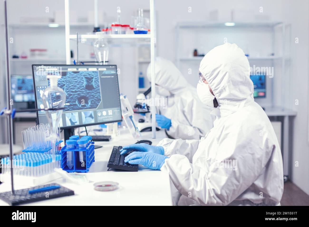 Research scientist typing information obtained working in modern ...