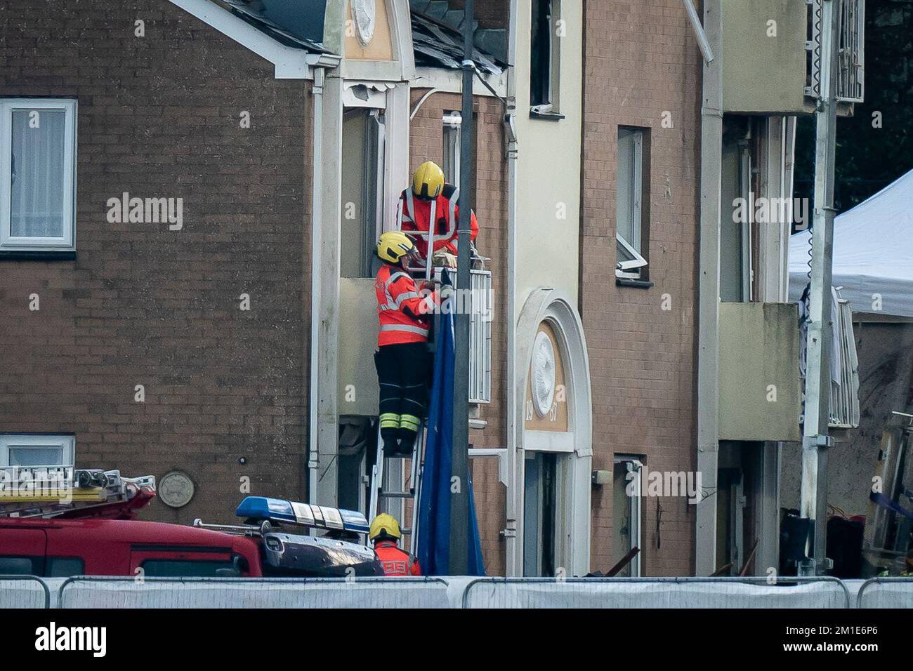Emergency personnel at the scene of an explosion and fire at a block of ...