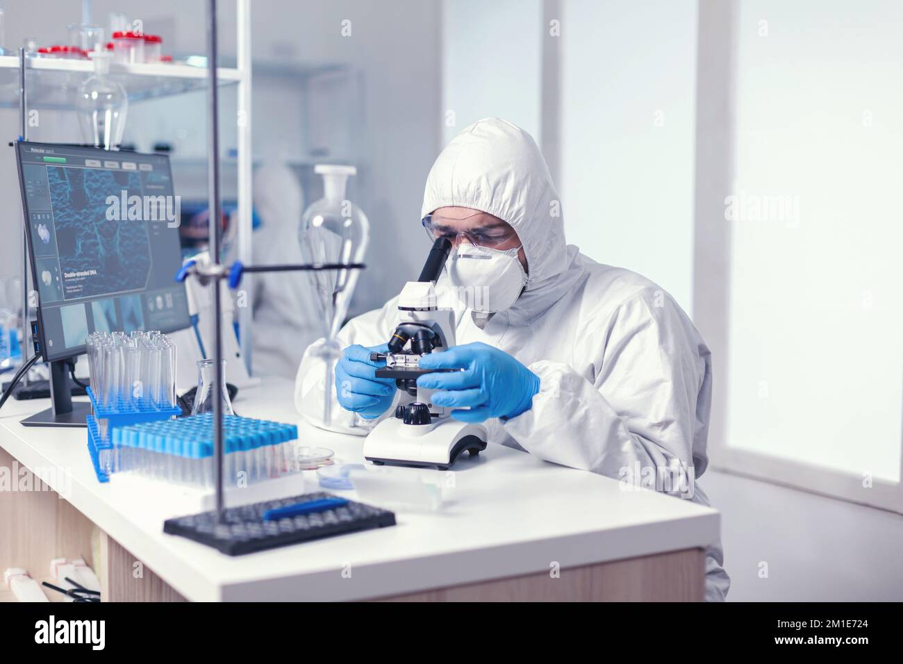 Biotechnology scientist in ppe suit researching cure for coronavirus ...
