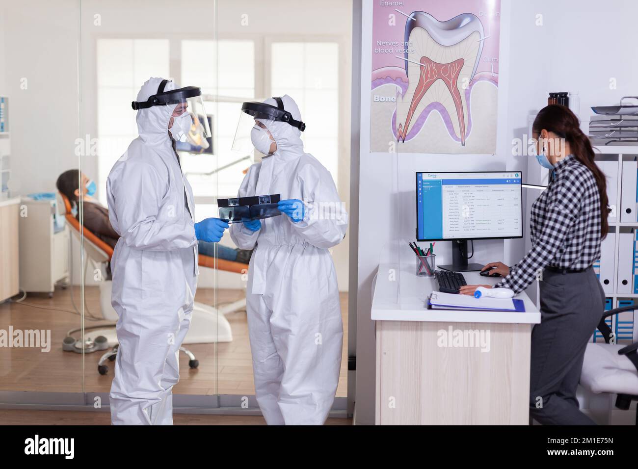 Dentist assistant discussing with doctor patient diagnosis keeping ...