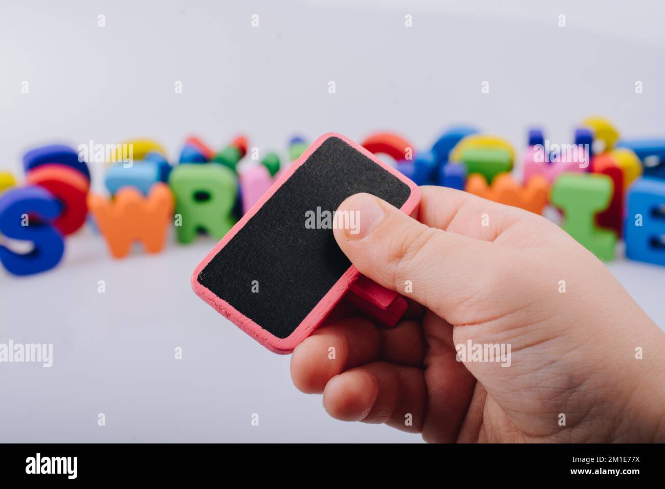 Hand holding a mini size notice board made of wood Stock Photo - Alamy