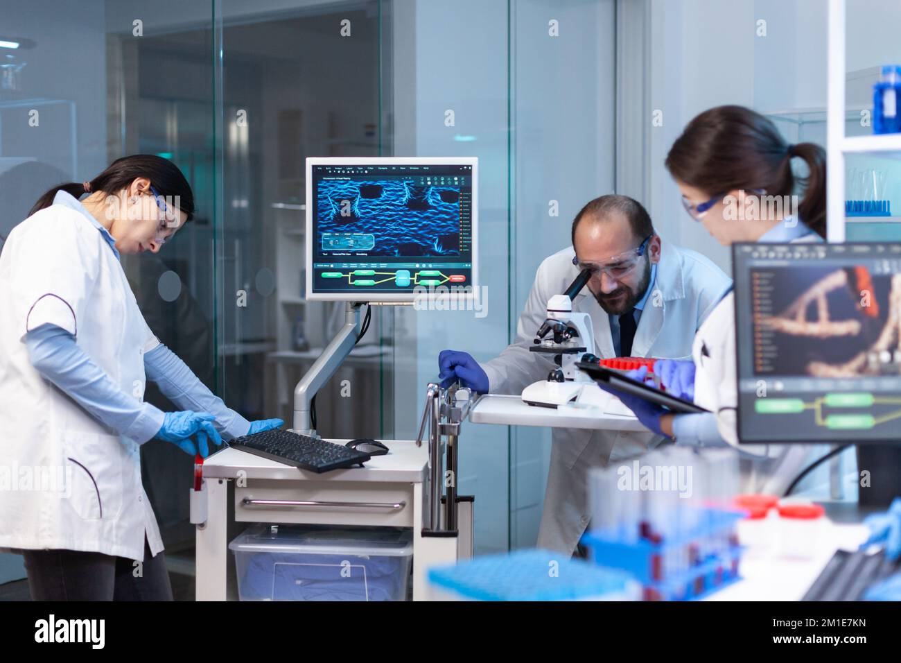 Team examining virus evolution and studying virus reaction. Chemists in ...