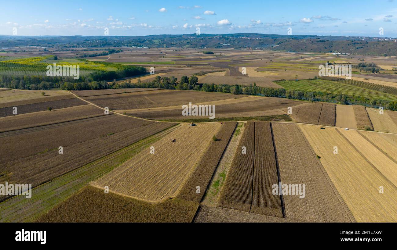 Farm field, farmers work with tractor on farmland Stock Photo - Alamy