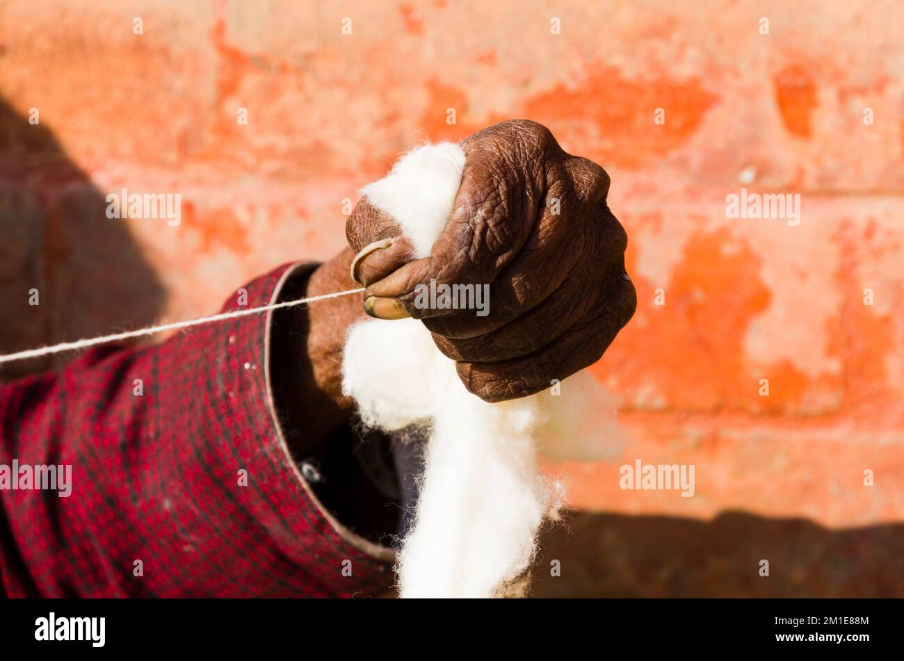 Old lady spinning thread on Durbar Square Stock Photo - Alamy