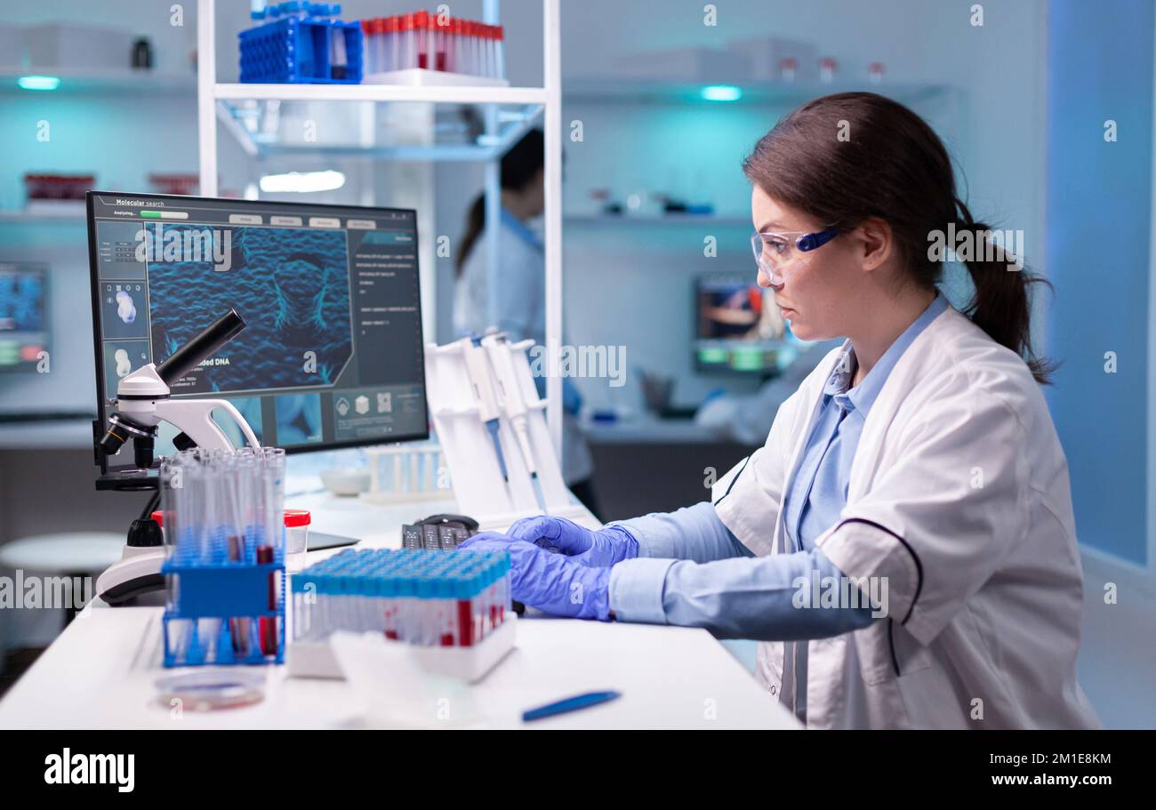 Concentrated professional woman scientist in laboratory with modern ...