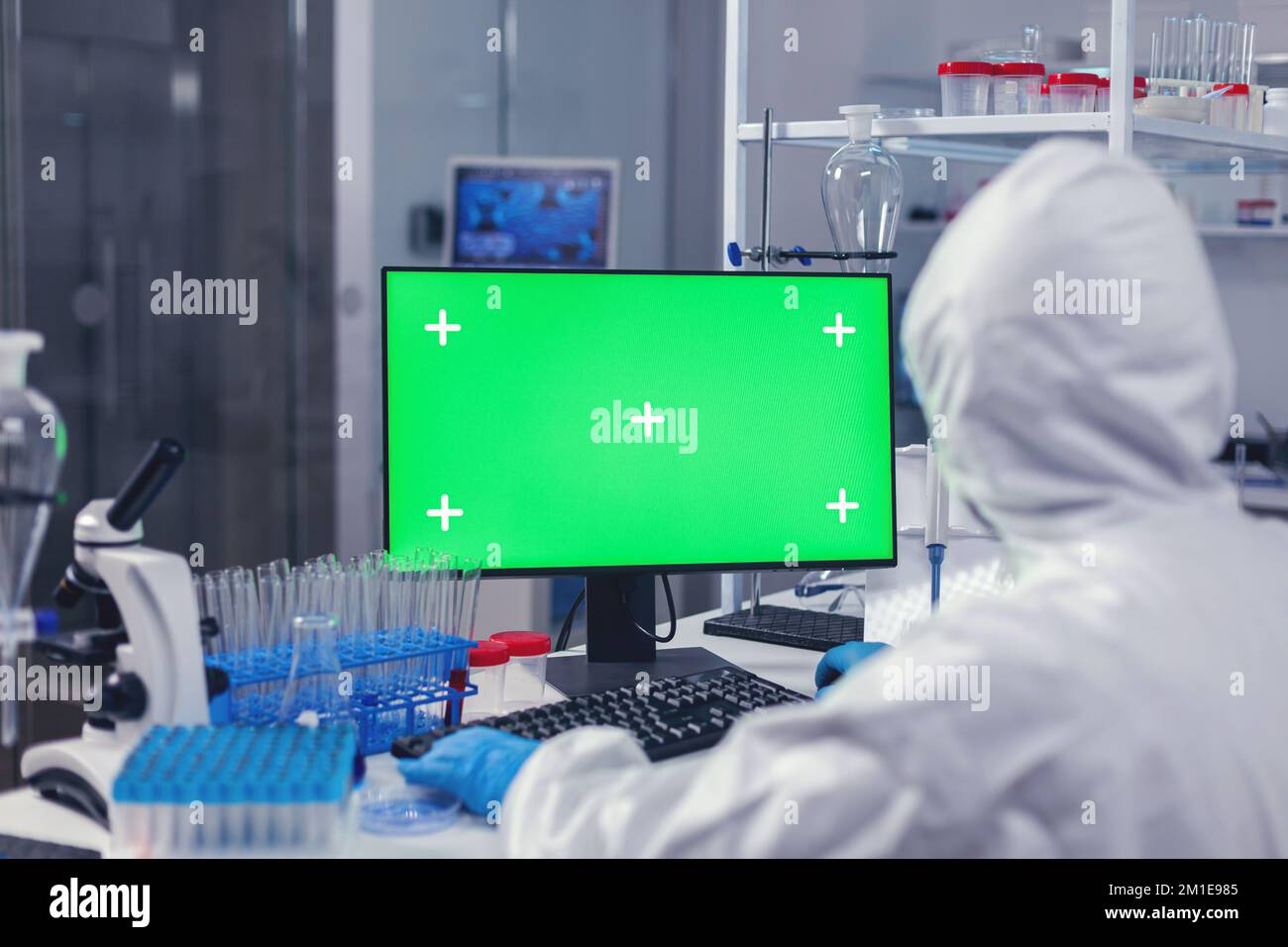 Researcher developing cure for covid19 using pc with green screen in ...