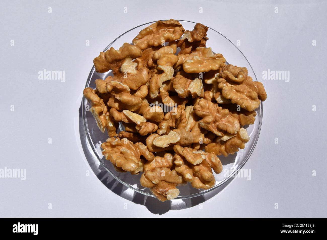 A plate full of ripe walnuts on the white background Stock Photo - Alamy