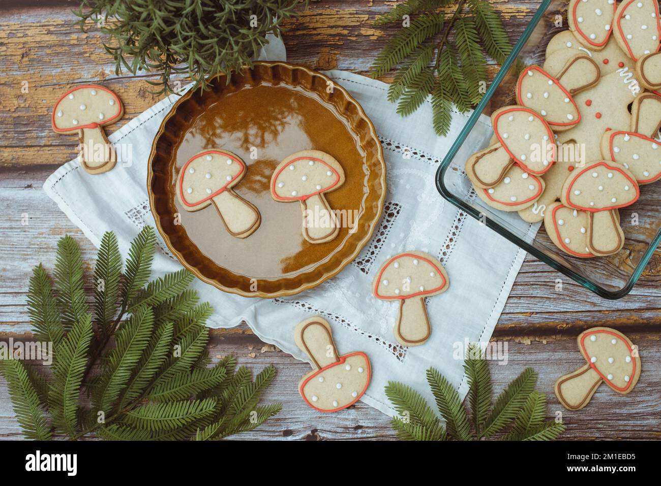 Overhead view of gingerbread mushroom cookie decorations on a wooden ...