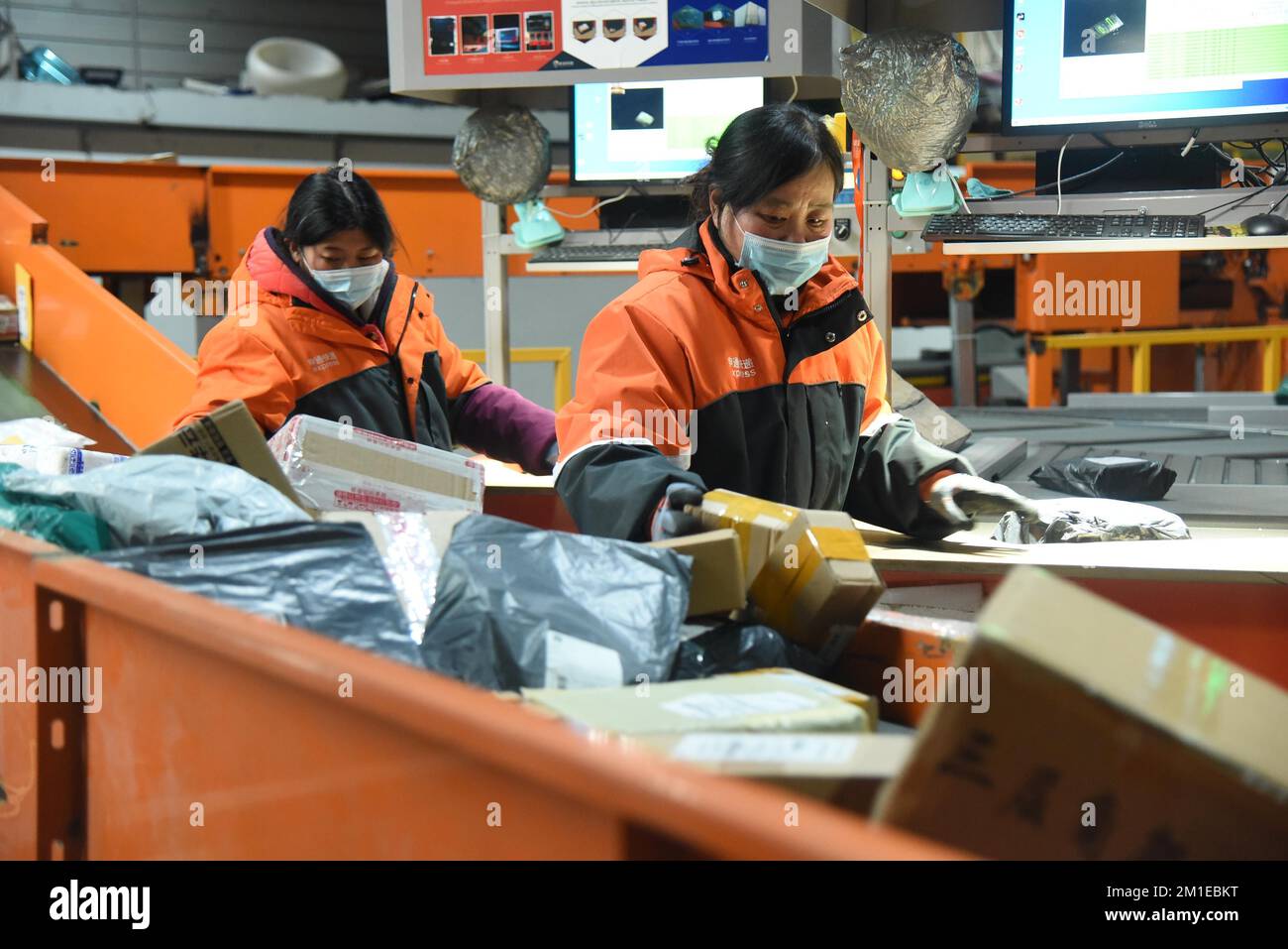 During the double 12 shopping carnival, workers are sorting express ...