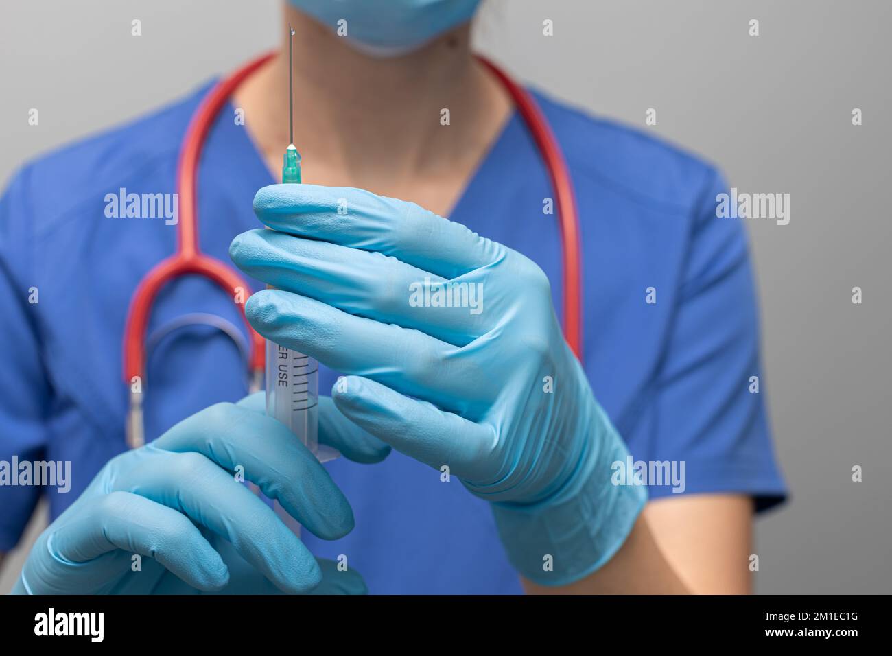 doctor holding a syringe with a needle. doctor holding a syringe ...