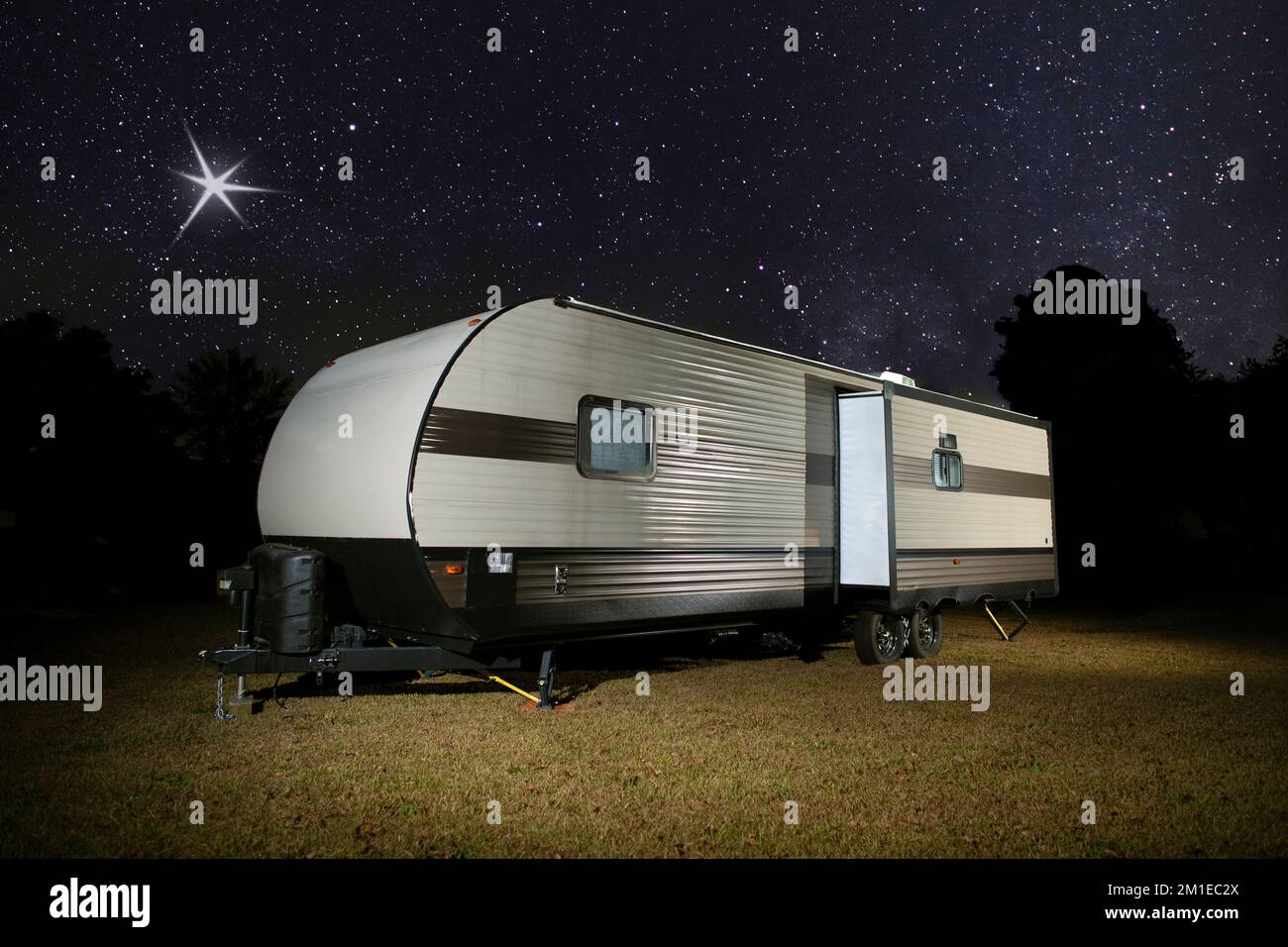 Camping trailer on a grassy spot with bright stars above Stock Photo ...