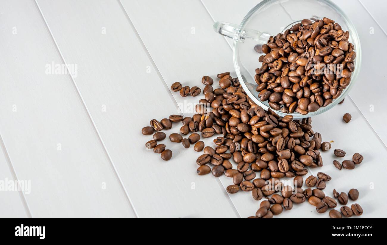 A closeup shot of coffee beans in a glass cup dropping down on the ...