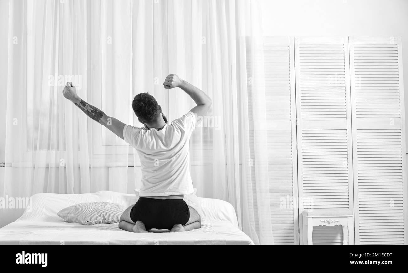 Guy stretching arms, full of energy in morning. Macho with beard ...