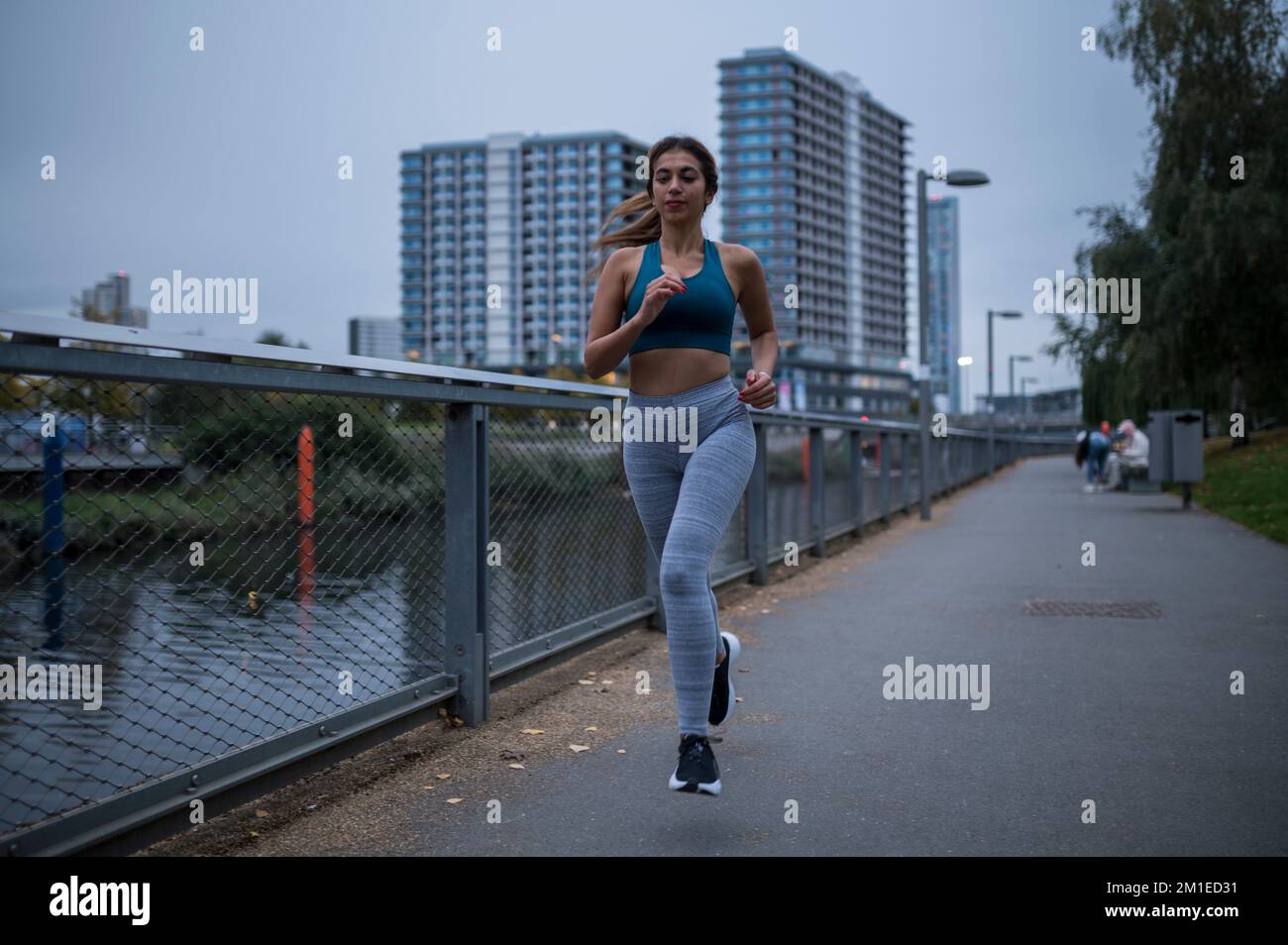 Female runner in Stratford Olympic Park, East London, England, UK Stock ...