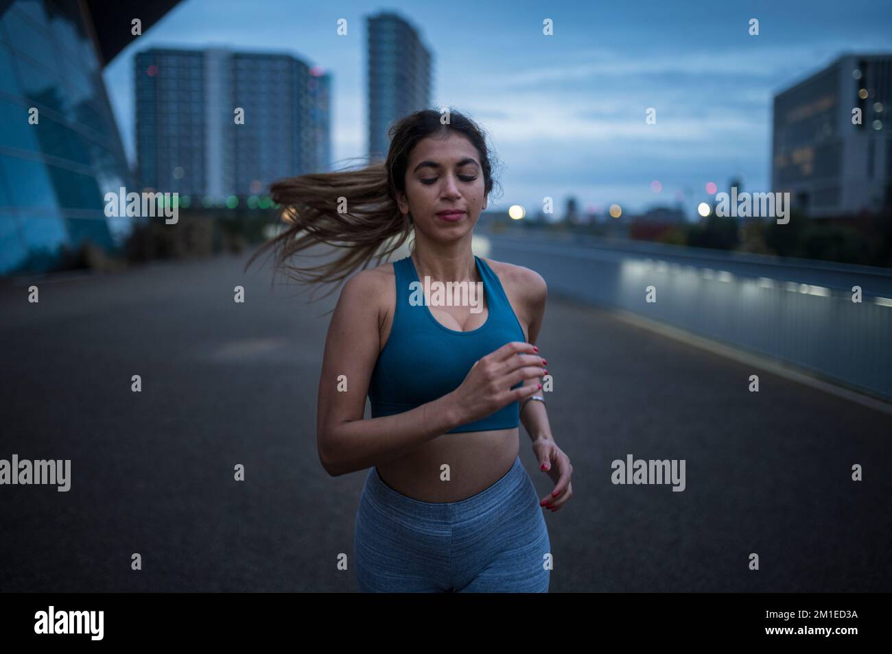 Female runner in Stratford Olympic Park, East London, England, UK Stock ...