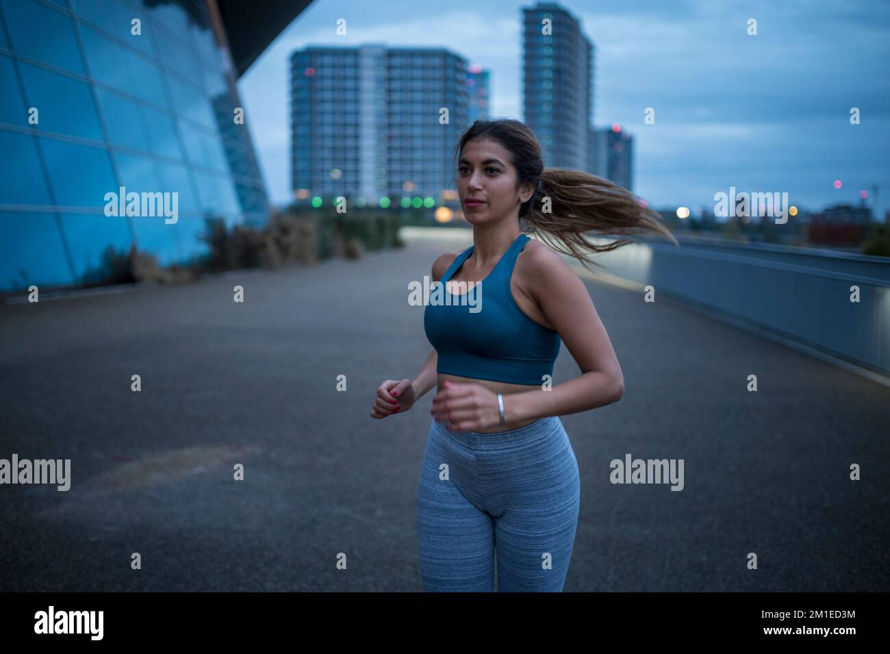 Female runner in Stratford Olympic Park, East London, England, UK Stock ...