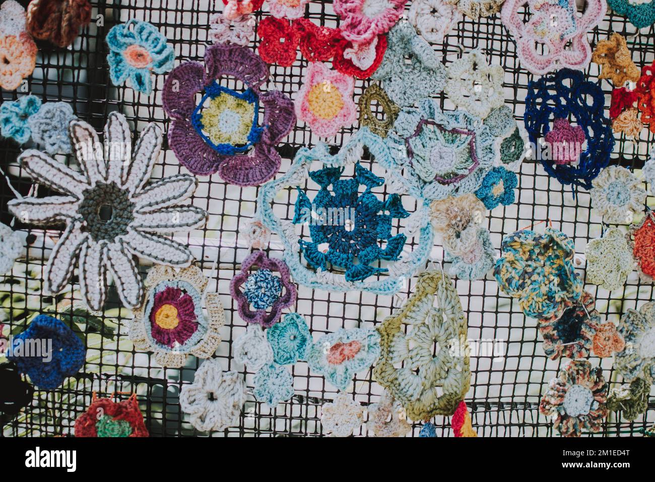 A top view of embroidered fabric with colorful flowers and leaves on it ...