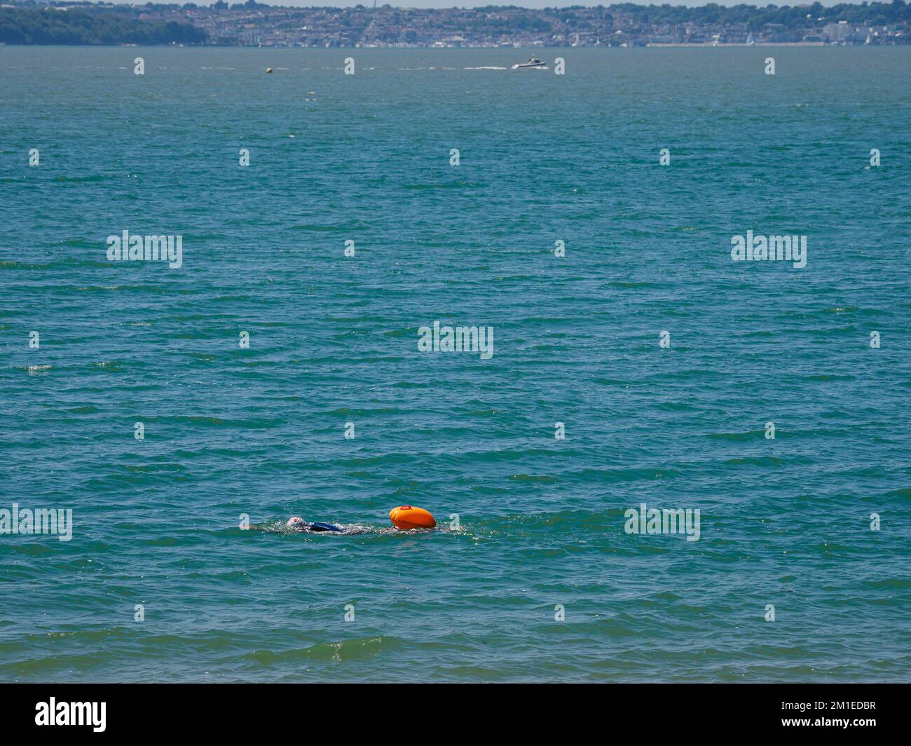 Sea swimmer with tow float in the Solent at Lee-on-the-Solent ...