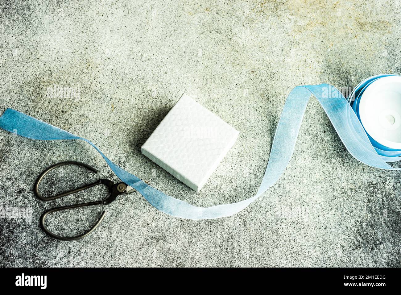 Gift box wrapping concept with present box and light blue ribbon on ...