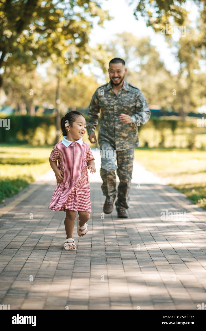 Dad and daughter having fun and running in the park Stock Photo - Alamy