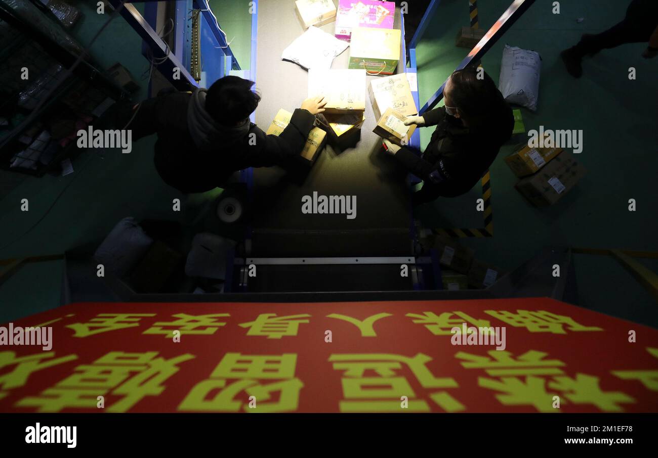CHENZHOU, CHINA - DECEMBER 12, 2022 - Staff members sort express ...