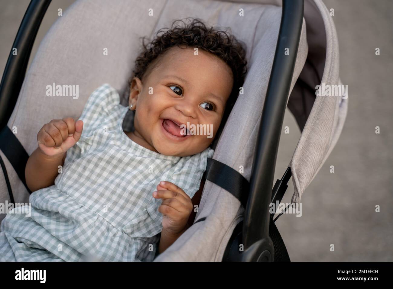 Close up of a smiling cute baby in a craddle Stock Photo - Alamy