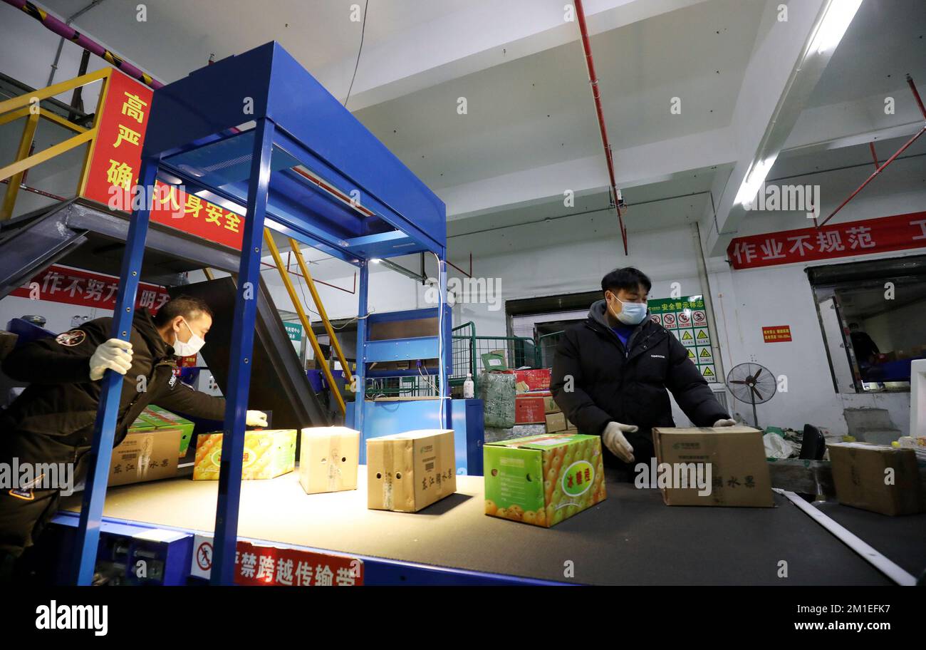 CHENZHOU, CHINA - DECEMBER 12, 2022 - Staff members sort express ...