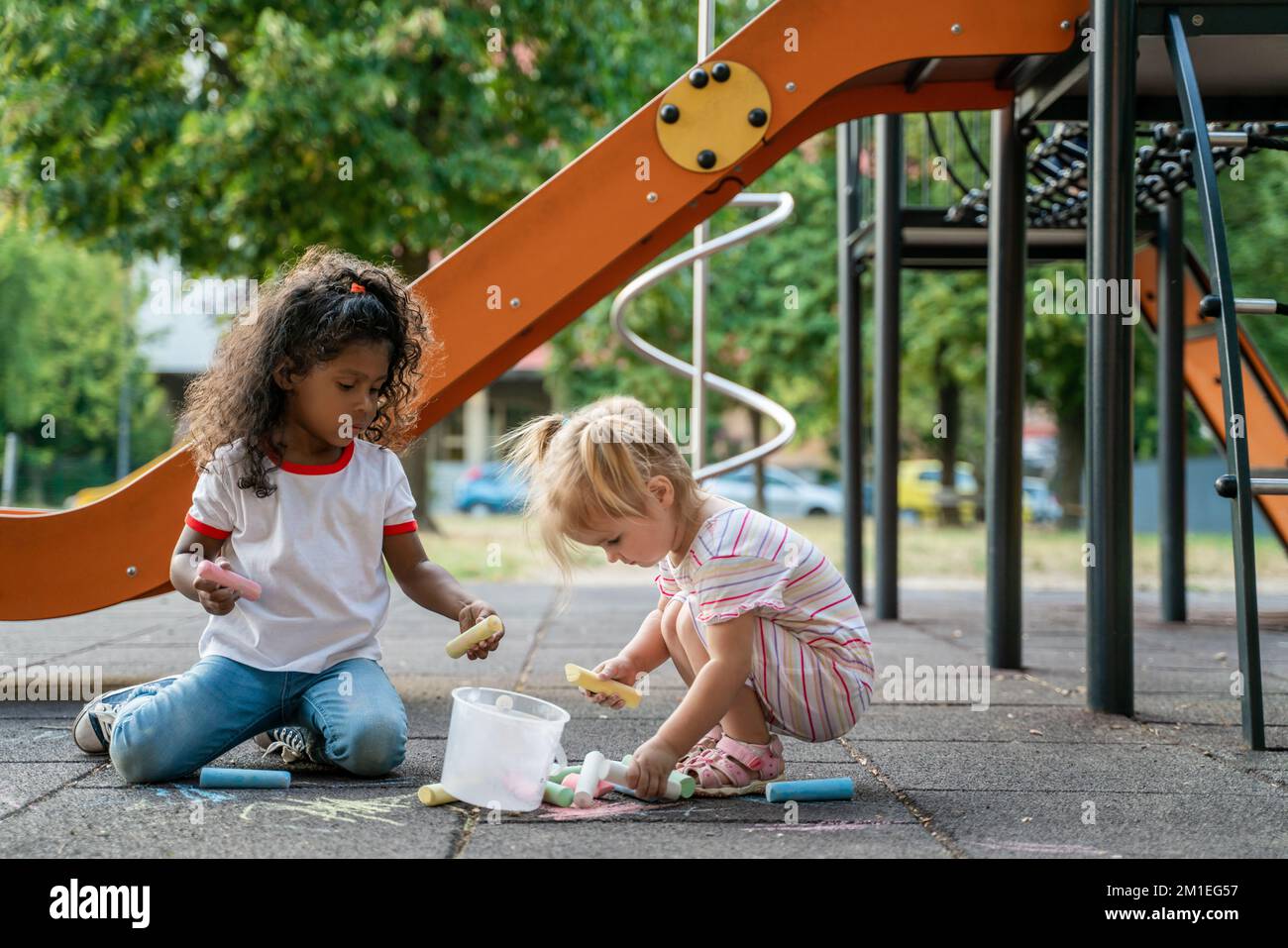 Two little girls playing togather on the playground Stock Photo - Alamy