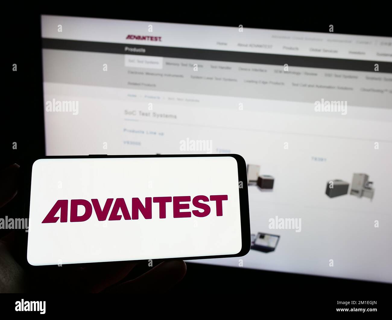 Person holding cellphone with logo of Japanese company Advantest ...