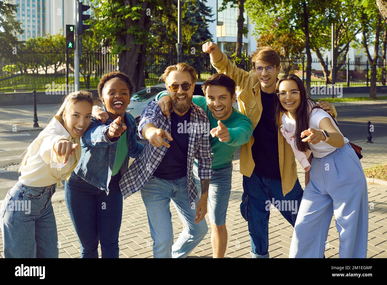 Group of happy young diverse people on city street smiling and pointing fingers at you Stock ...