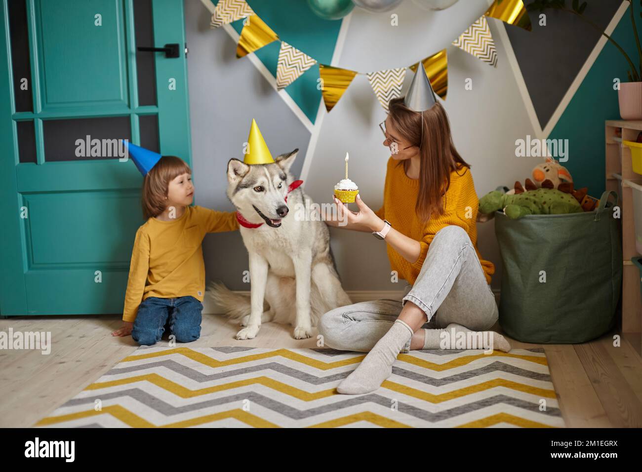 Dog pet birthday party, Happy family mother and child congratulating ...