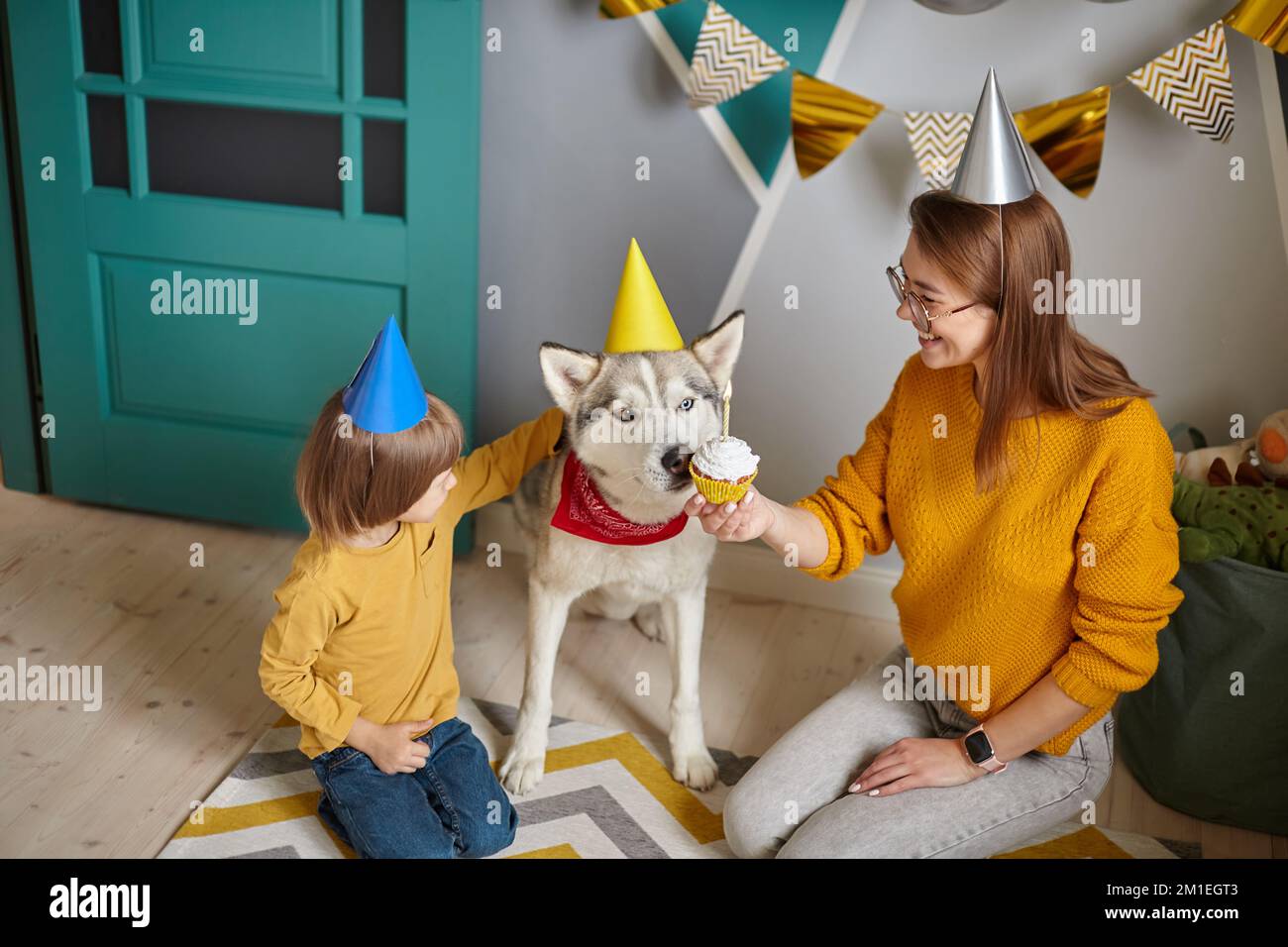 Dog pet birthday party, Happy family mother and child congratulating ...